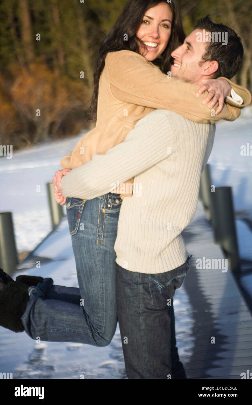 Man picking up woman, laughing Stock Photo - Alamy