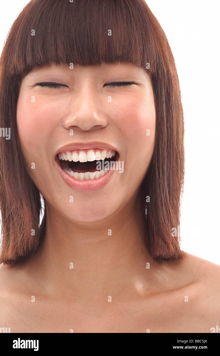 Young woman with fringe, laughing Stock Photo - Alamy