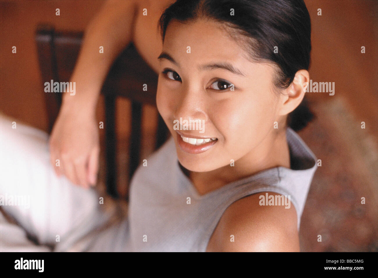 Young woman sitting, smiling, elevated view Stock Photo - Alamy