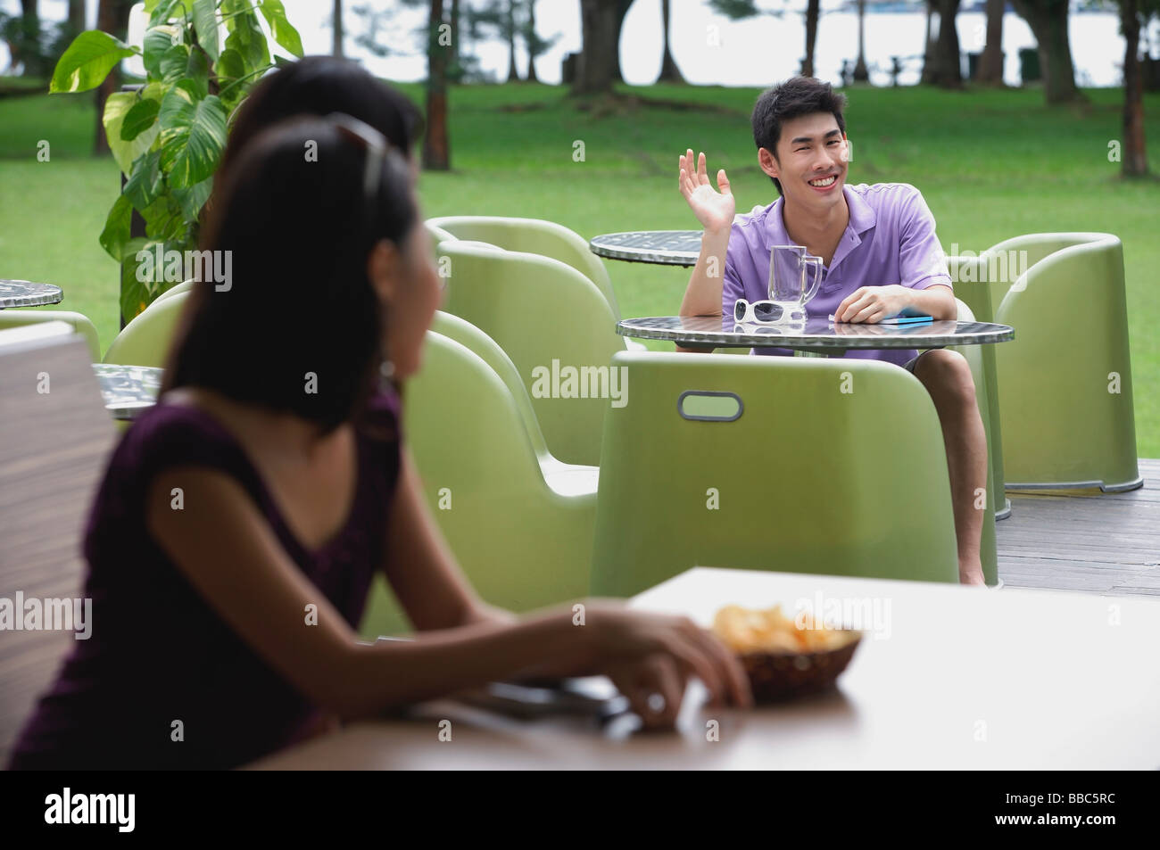 Cheerful casual young man waving hi-res stock photography and images ...