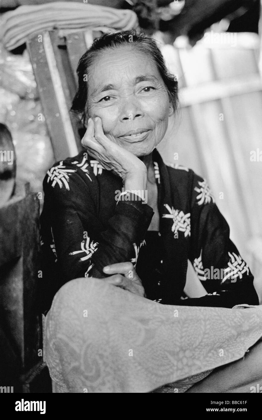 Indonesia, Java, Portrait of lady resting head on hand, smiling Stock ...