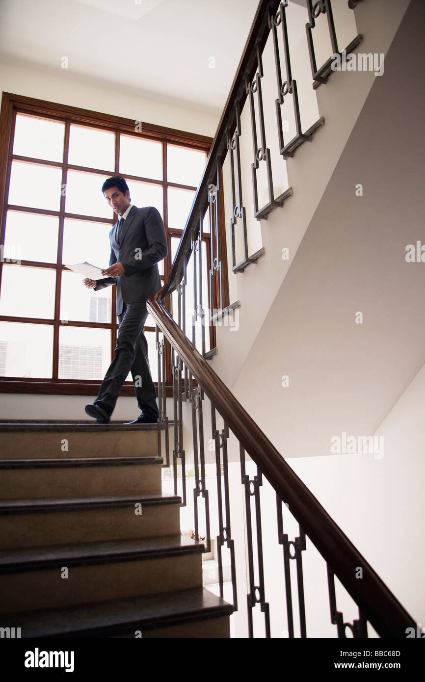 businessman walking down the stairs Stock Photo - Alamy