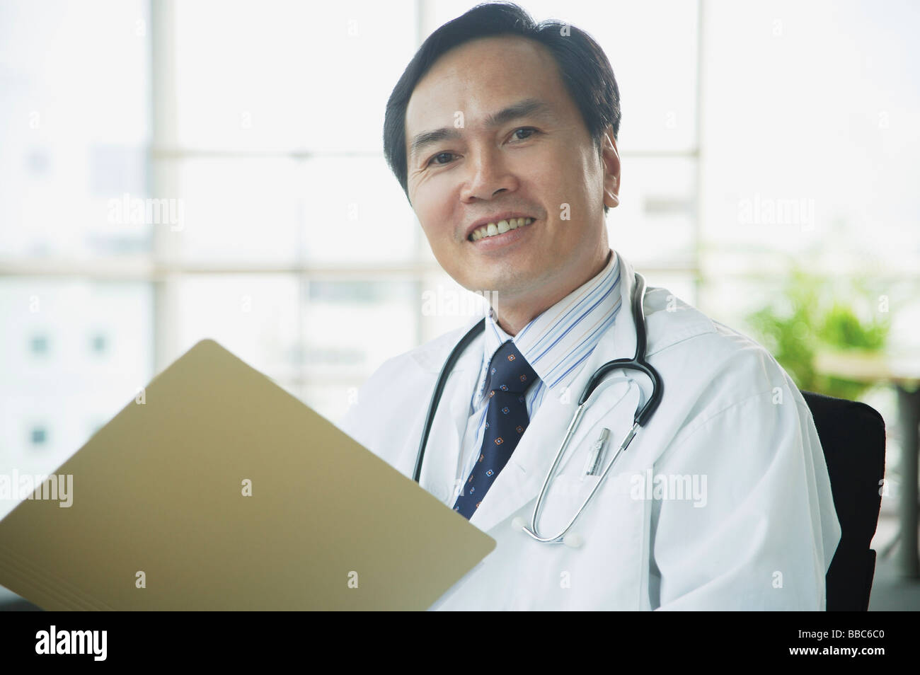 Doctor smiling at camera Stock Photo - Alamy