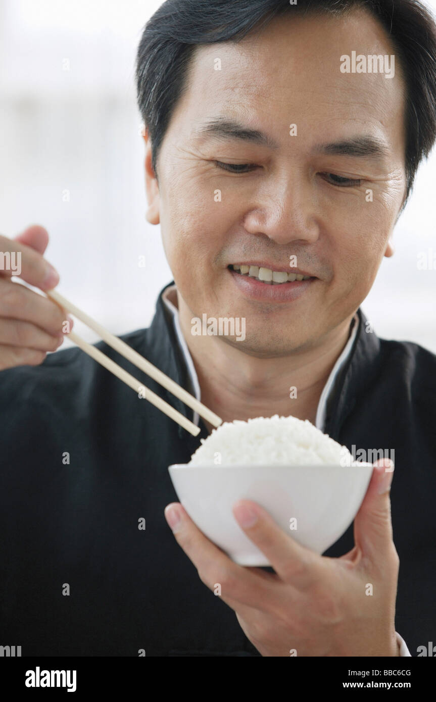 Man eating rice Stock Photo - Alamy
