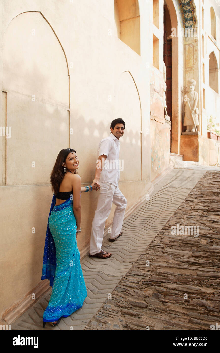 young man holding woman's hand, walking up a slope Stock Photo - Alamy