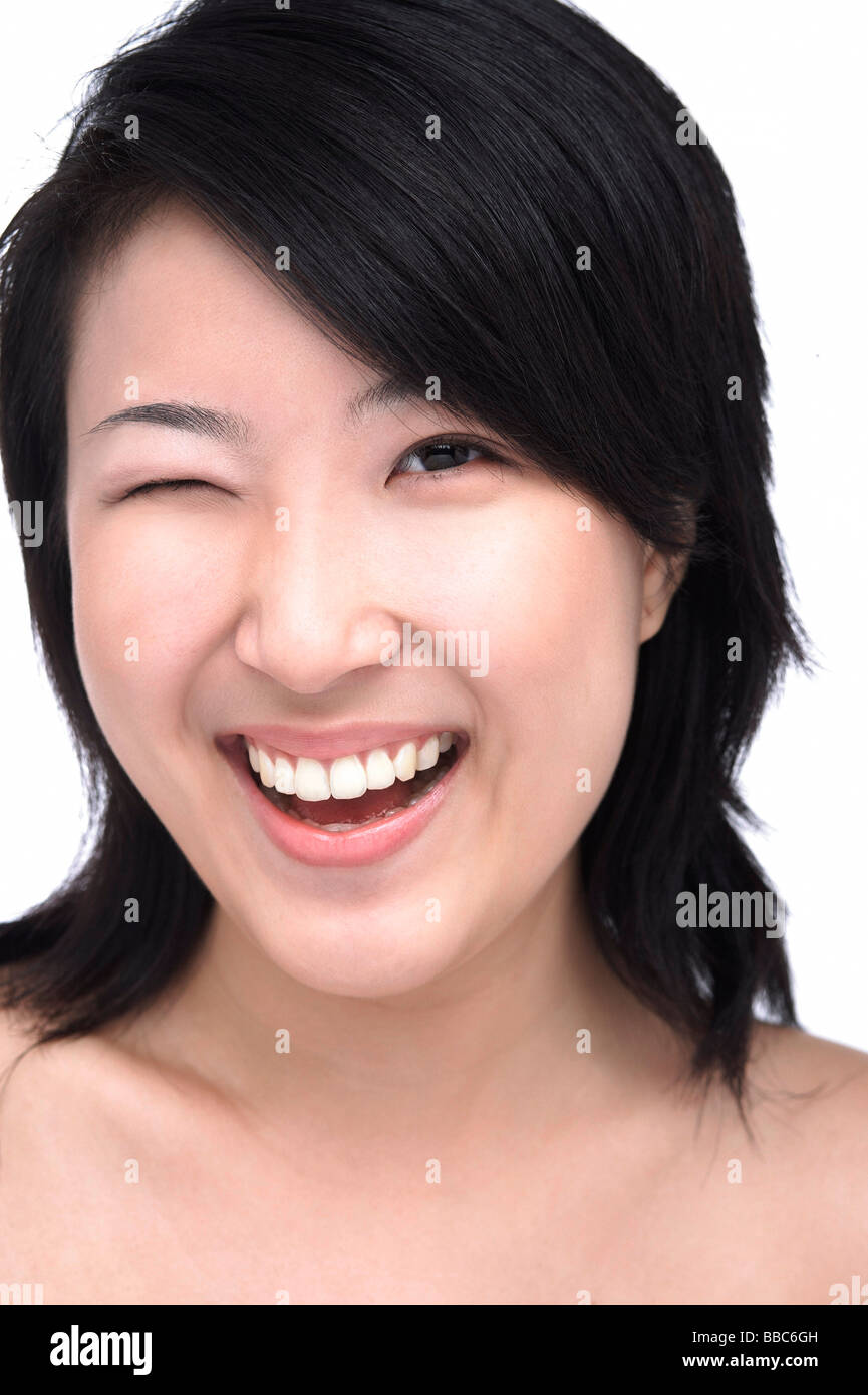Young woman winking Stock Photo - Alamy