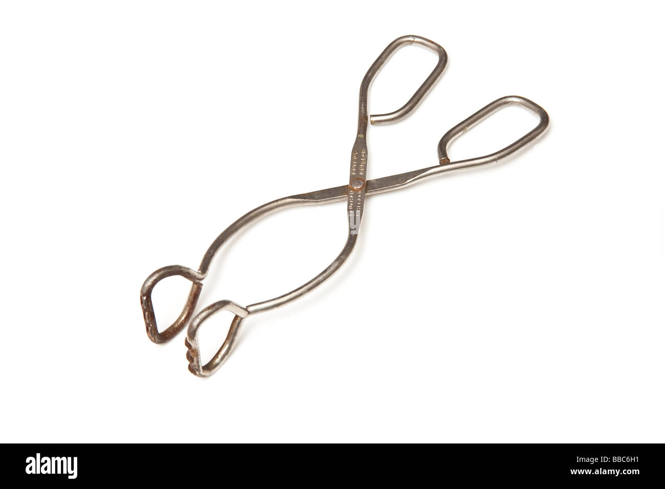 Metal tongs isolated on a white studio background Stock Photo - Alamy