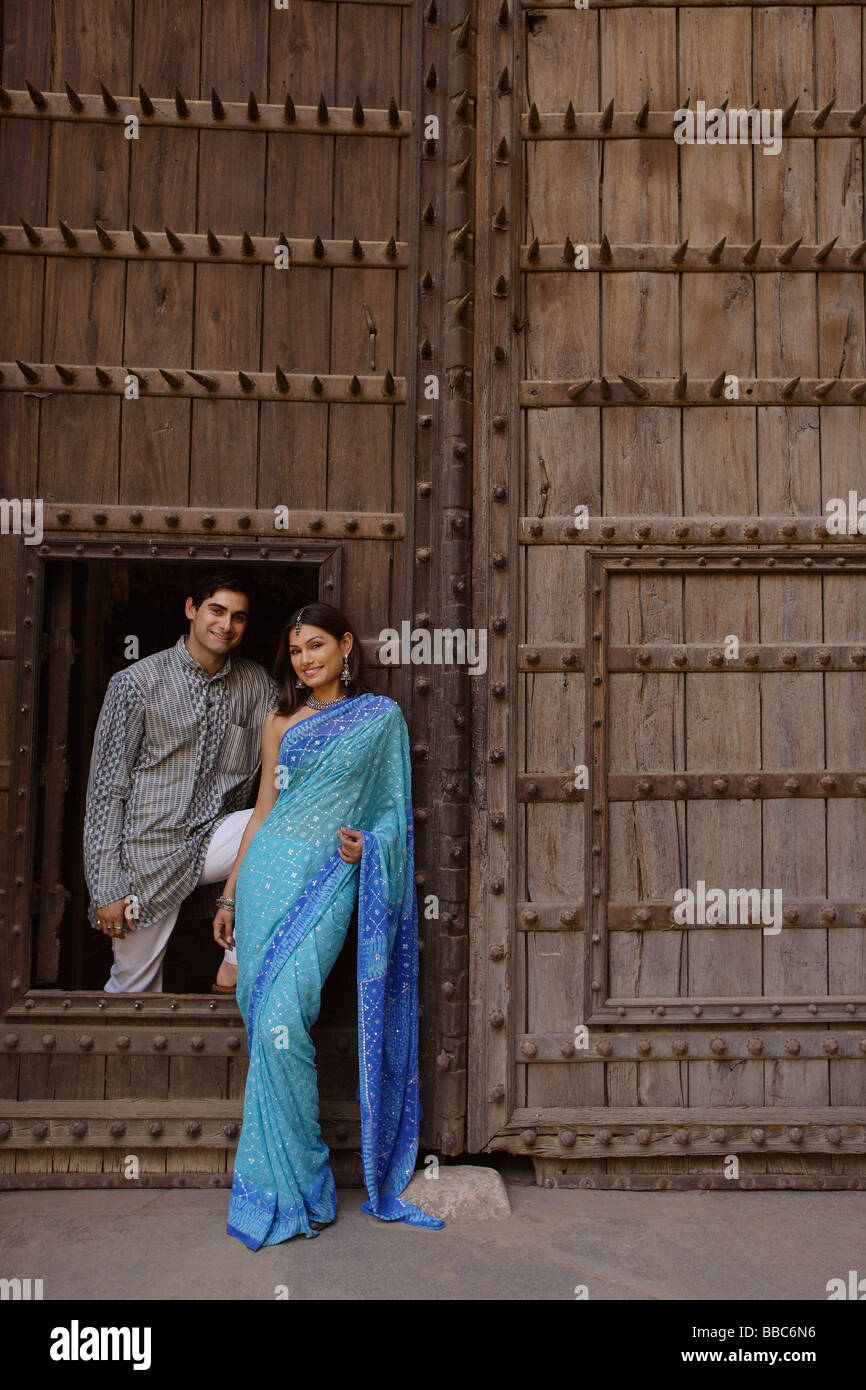young couple posing at wooden doorway Stock Photo - Alamy