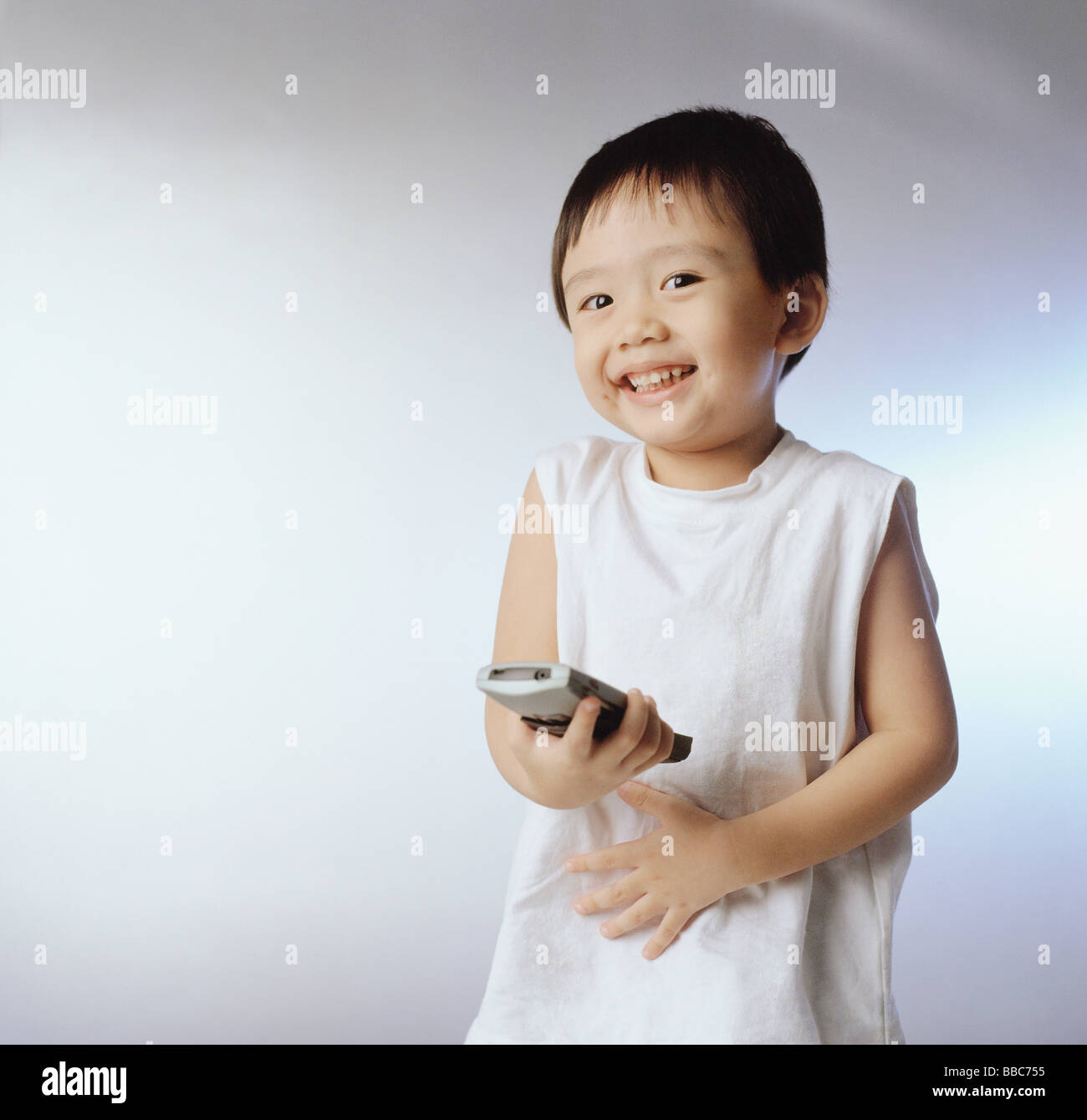 Boy, 3 years old holding remote control, smiling Stock Photo - Alamy