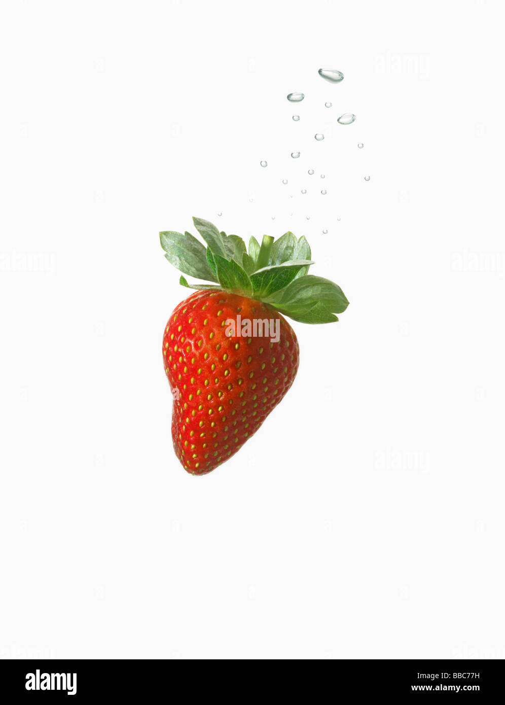 Strawberry in water, white background Stock Photo - Alamy