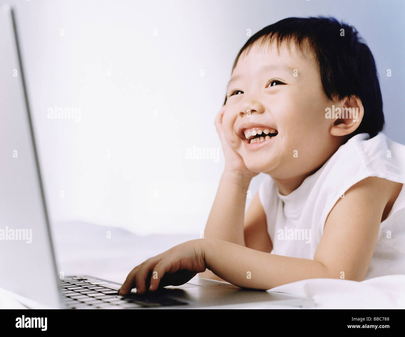 Boy, 3 years old, using laptop, smiling Stock Photo - Alamy