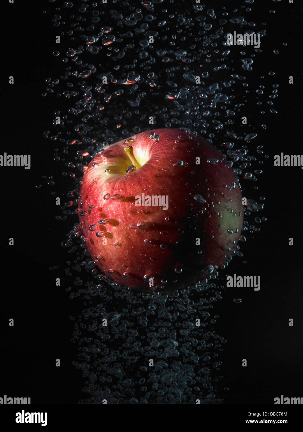 Apple in bubbles, black background Stock Photo - Alamy