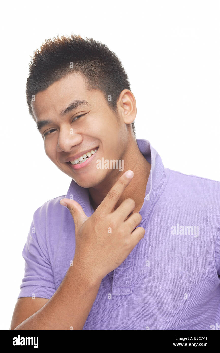 Man smiling, making hand sign Stock Photo - Alamy