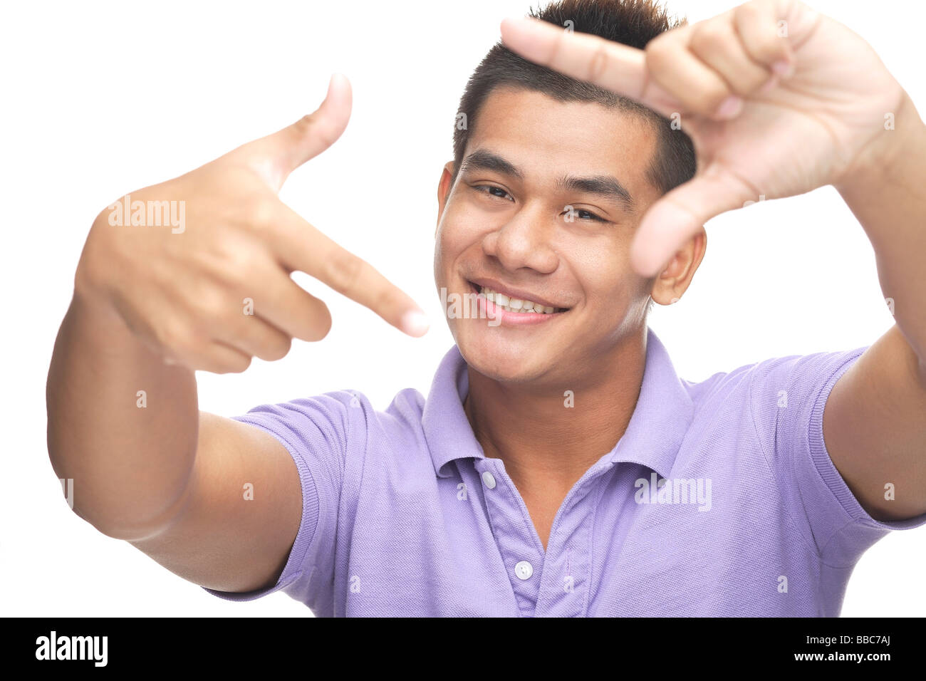 Man smiling at camera, making finger frame Stock Photo - Alamy
