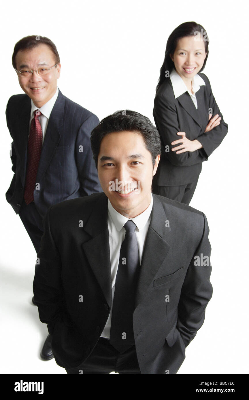 Executives standing together, smiling at camera Stock Photo - Alamy