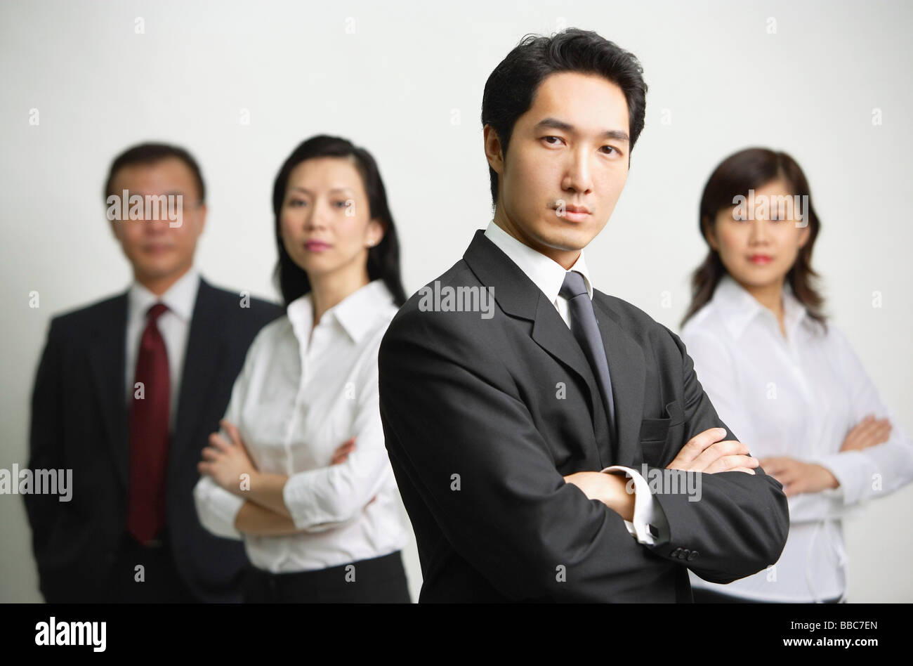 Four business people looking at camera Stock Photo - Alamy