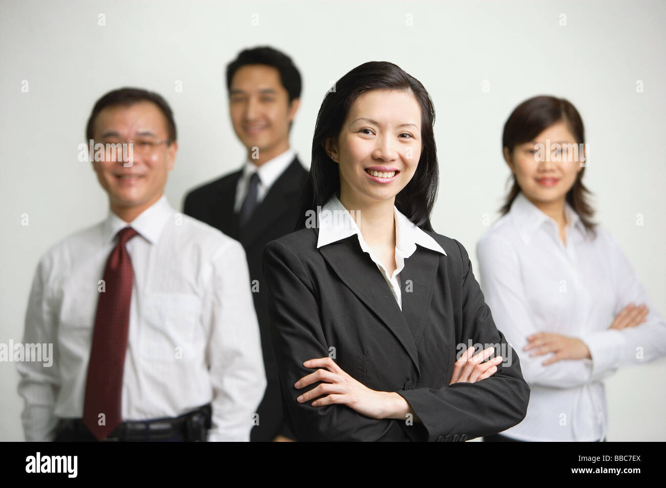 Executives standing together, arms crossed Stock Photo - Alamy