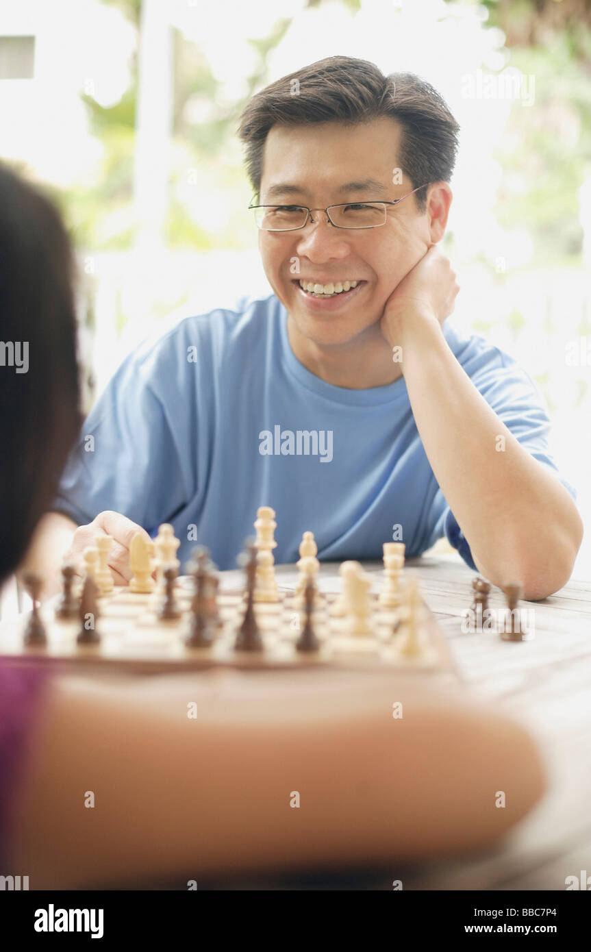 Father playing a game of chess with daughter Stock Photo - Alamy