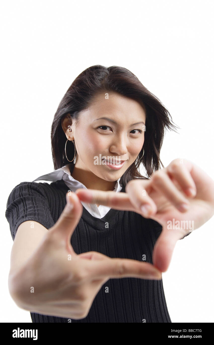 Young woman making hand sign Stock Photo - Alamy