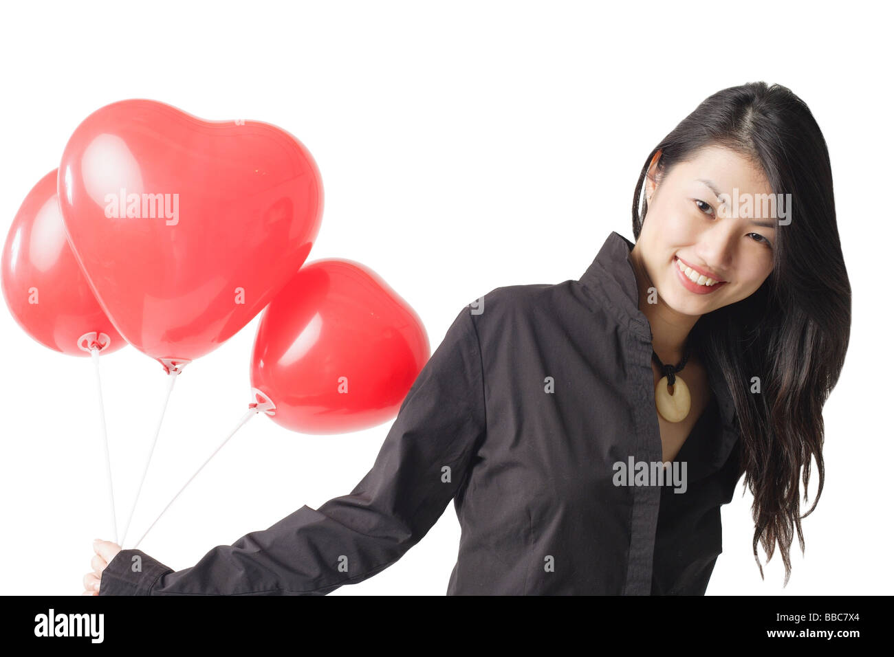 Woman holding three red balloons, portrait Stock Photo - Alamy