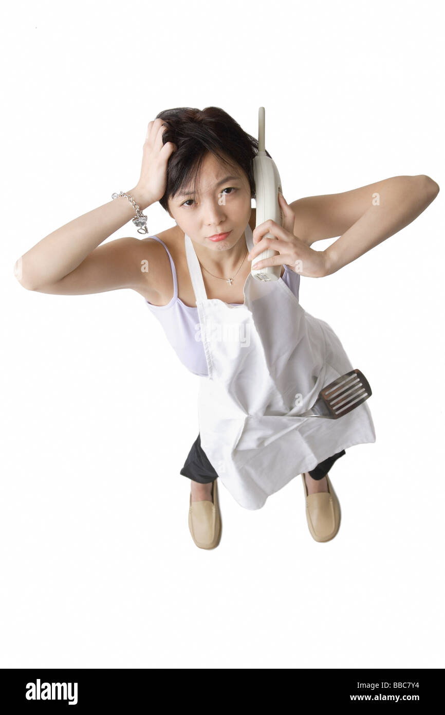 Woman in apron using cordless phone hi-res stock photography and images ...