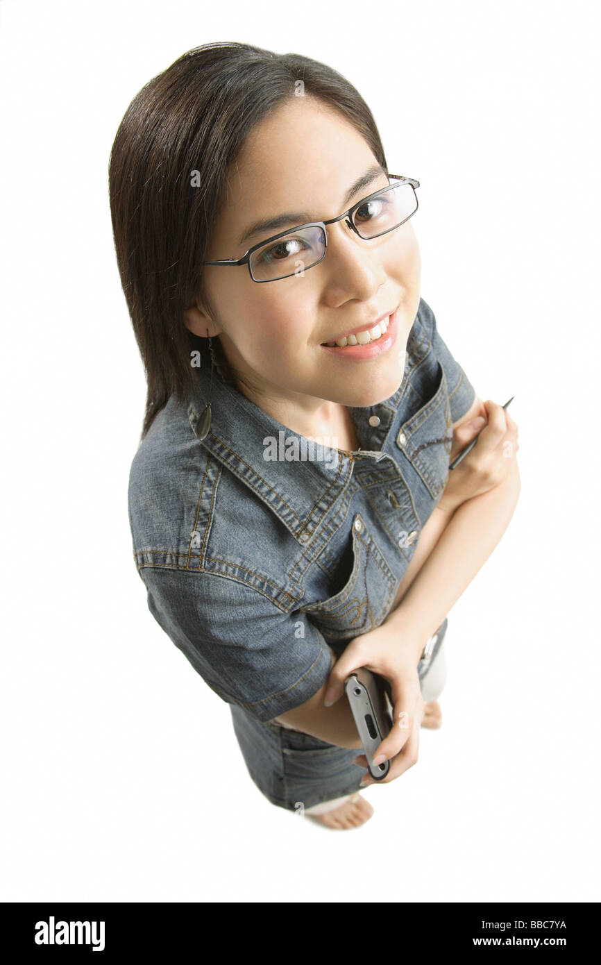 Young woman with glasses, arms crossed, smiling at camera Stock Photo ...