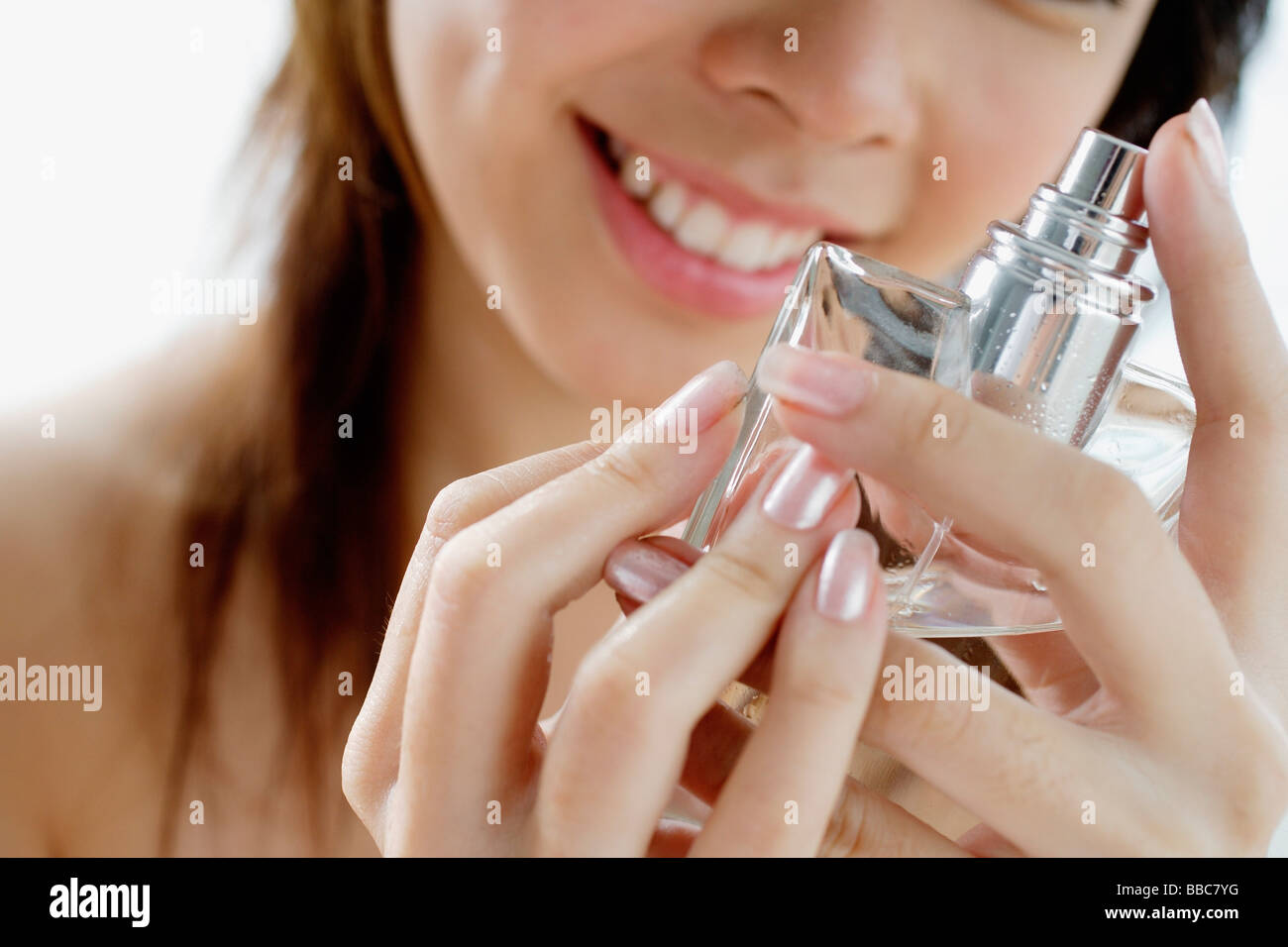 Young woman with perfume bottle Stock Photo - Alamy