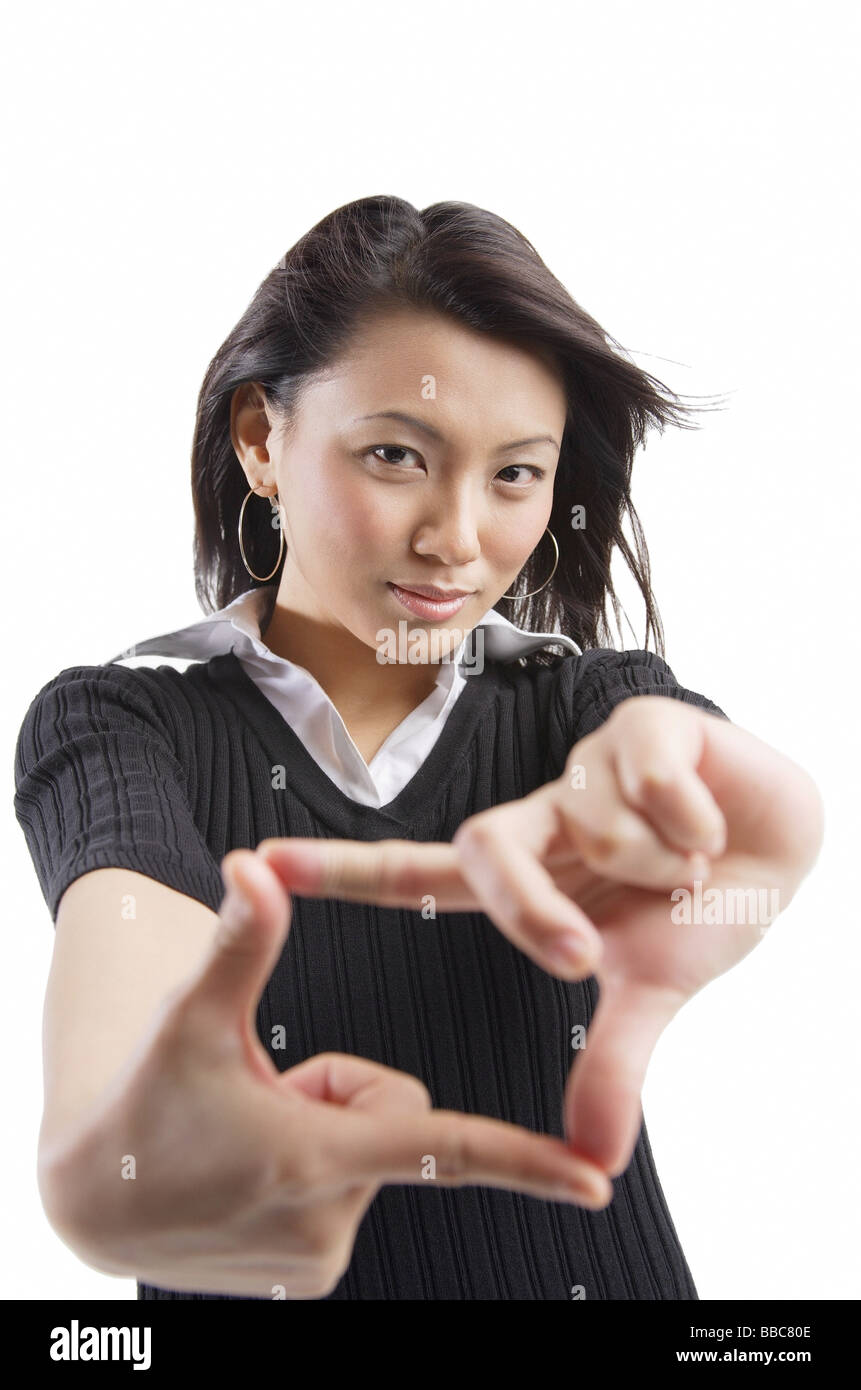 Young woman making hand sign Stock Photo - Alamy