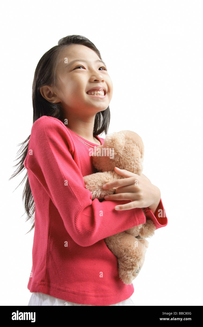 Girl hugging teddy bear Stock Photo - Alamy