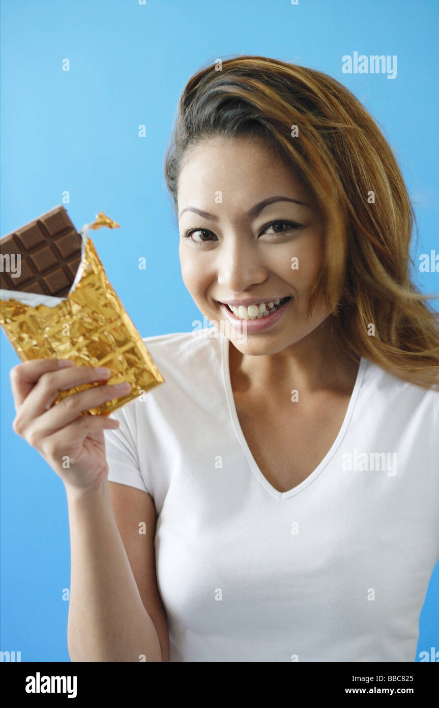 Women holding chocolate bar hi-res stock photography and images - Alamy