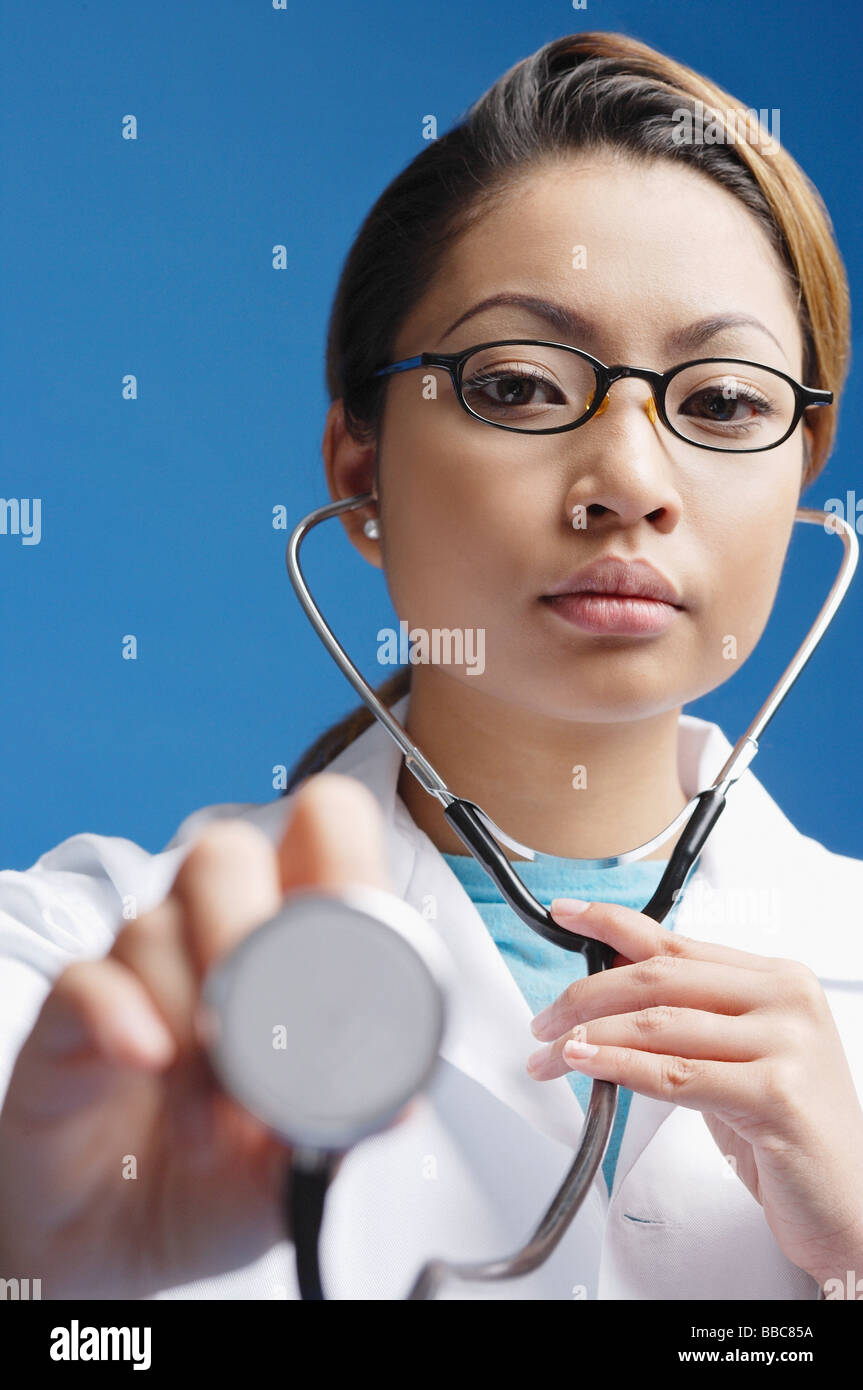 Doctor using stethoscope Stock Photo - Alamy