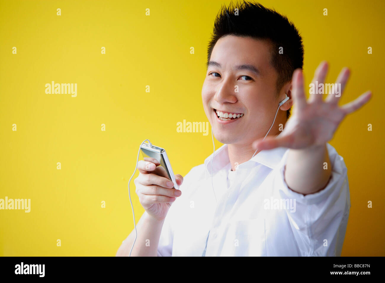 Man listening to MP3 Player, hand reaching towards camera Stock Photo ...