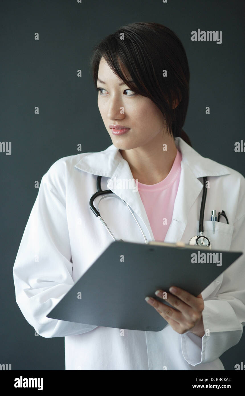 Female doctor standing sideways hi-res stock photography and images - Alamy