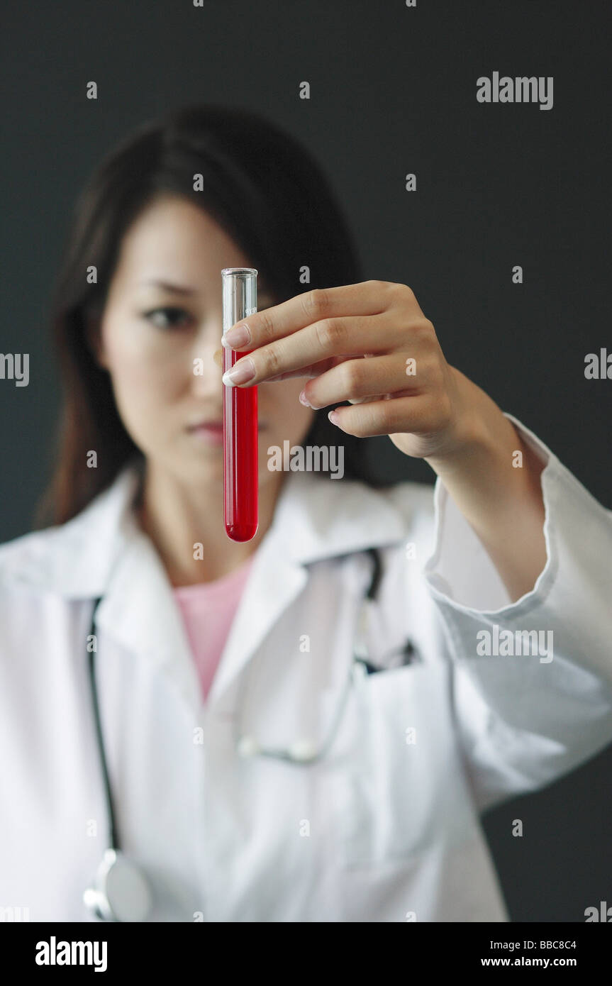 Doctor holding test tube filled with red liquid hi-res stock ...