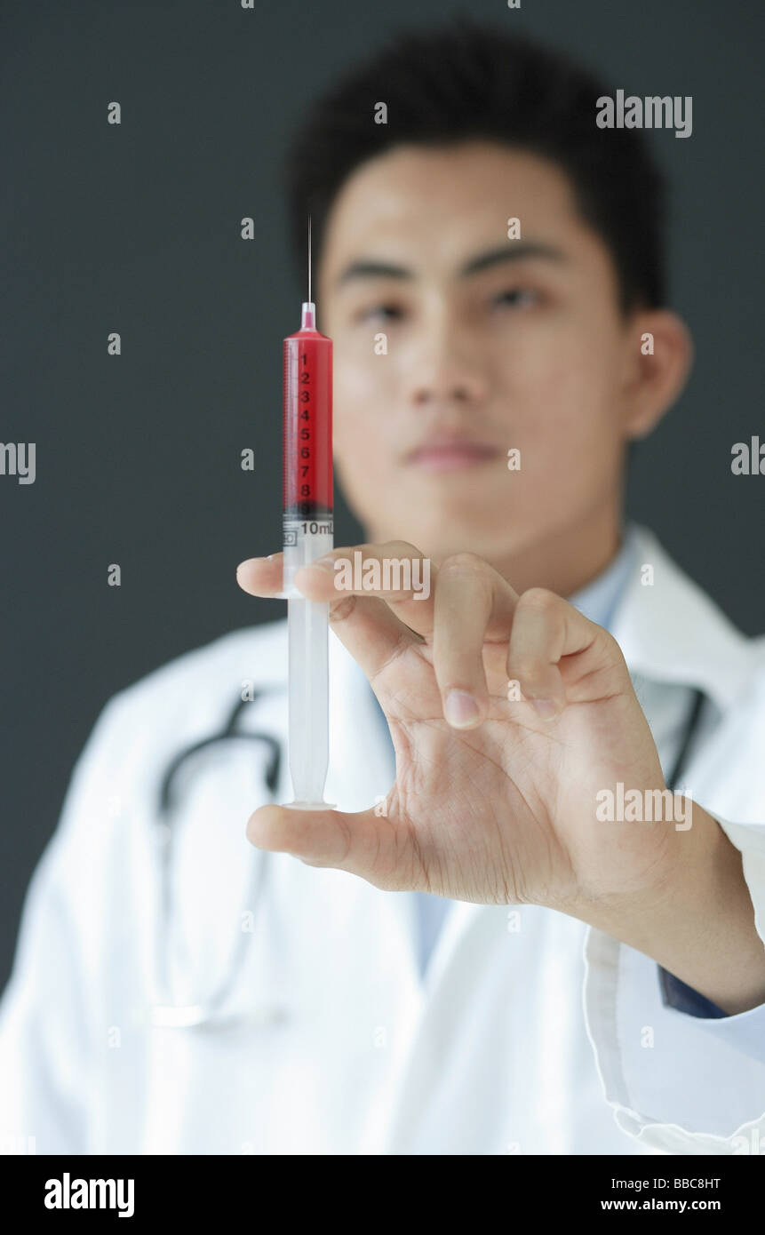 Doctor holding syringe Stock Photo - Alamy