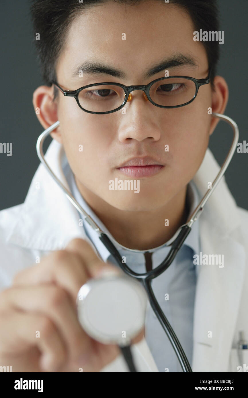 Doctor using stethoscope Stock Photo - Alamy