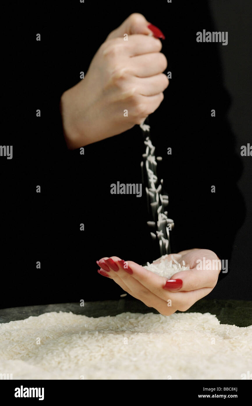 Woman pouring rice into cupped hands Stock Photo - Alamy
