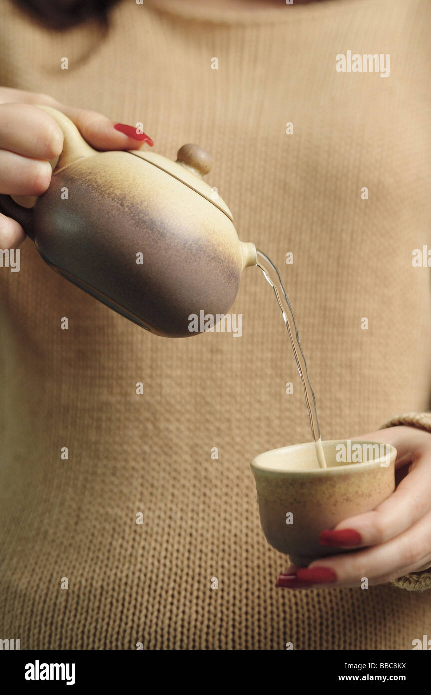 Woman pouring tea Stock Photo - Alamy