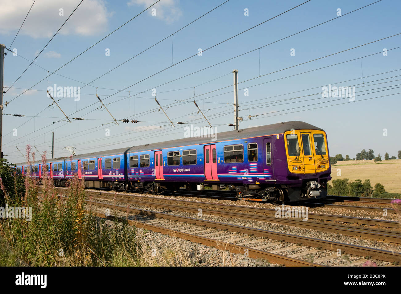 Passenger train class 319 in First Capital Connect livery speeding ...