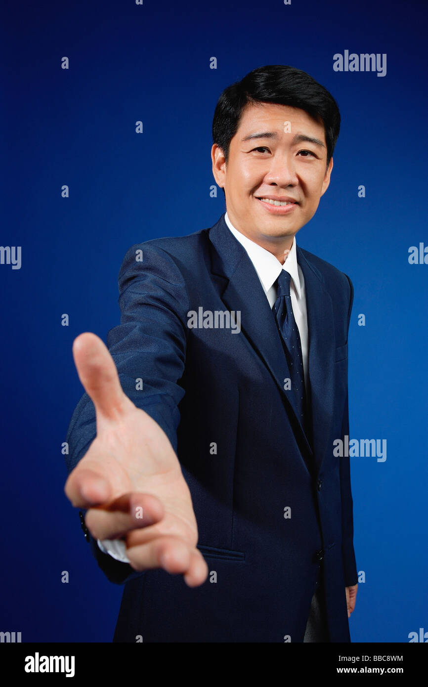 Businessman with hand outstretched Stock Photo - Alamy