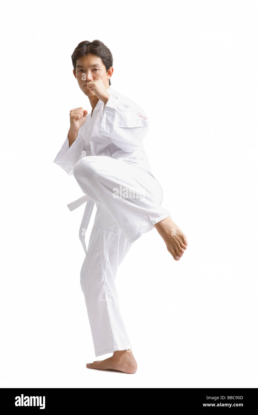 Young man practicing martial arts, preparing to kick Stock Photo - Alamy