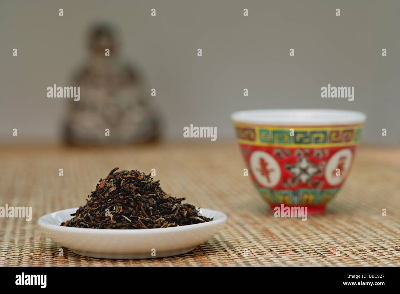 Chinese teacup and plate of tea leaves, still life Stock Photo - Alamy