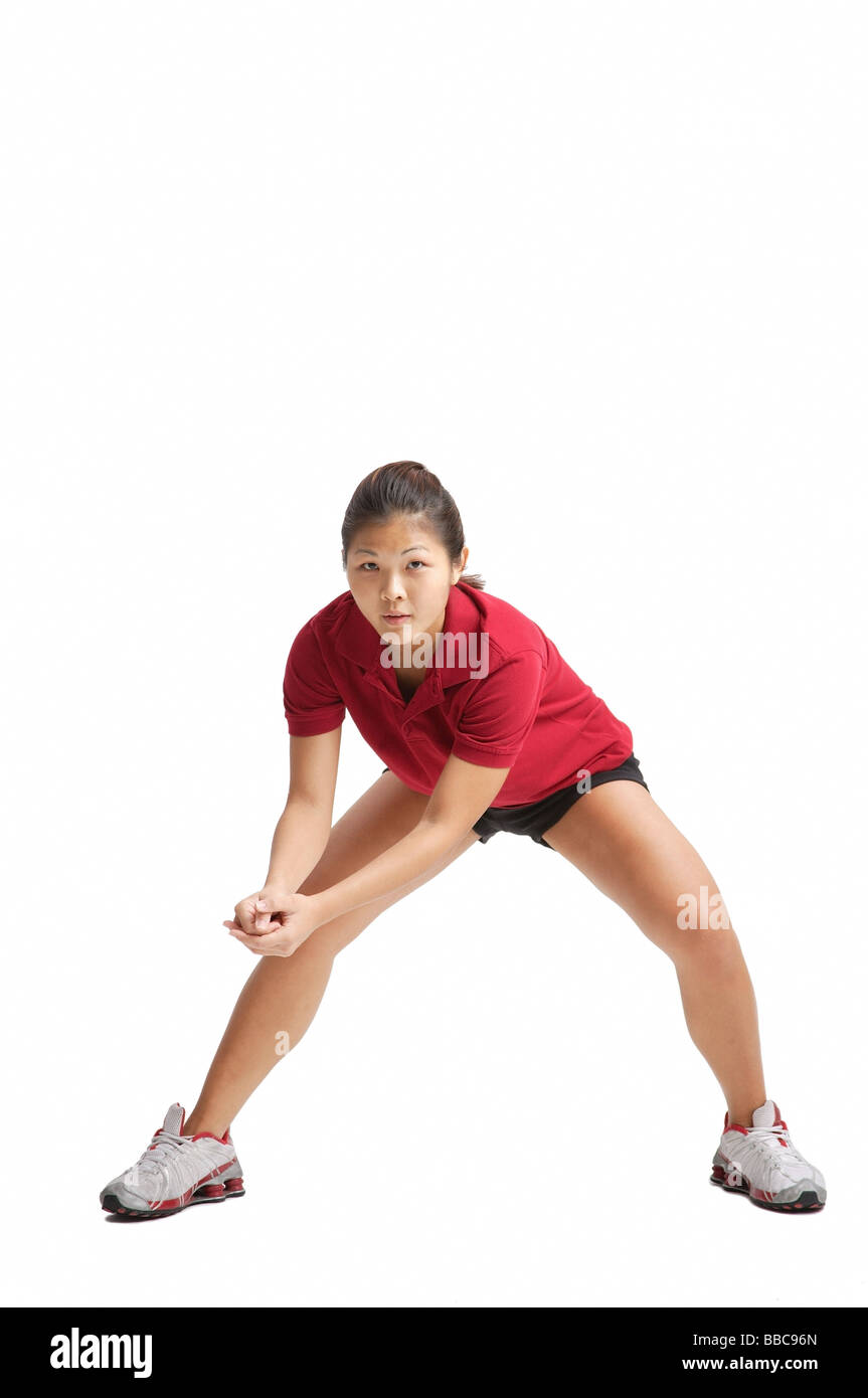 Young woman bending down, waiting for volleyball Stock Photo - Alamy