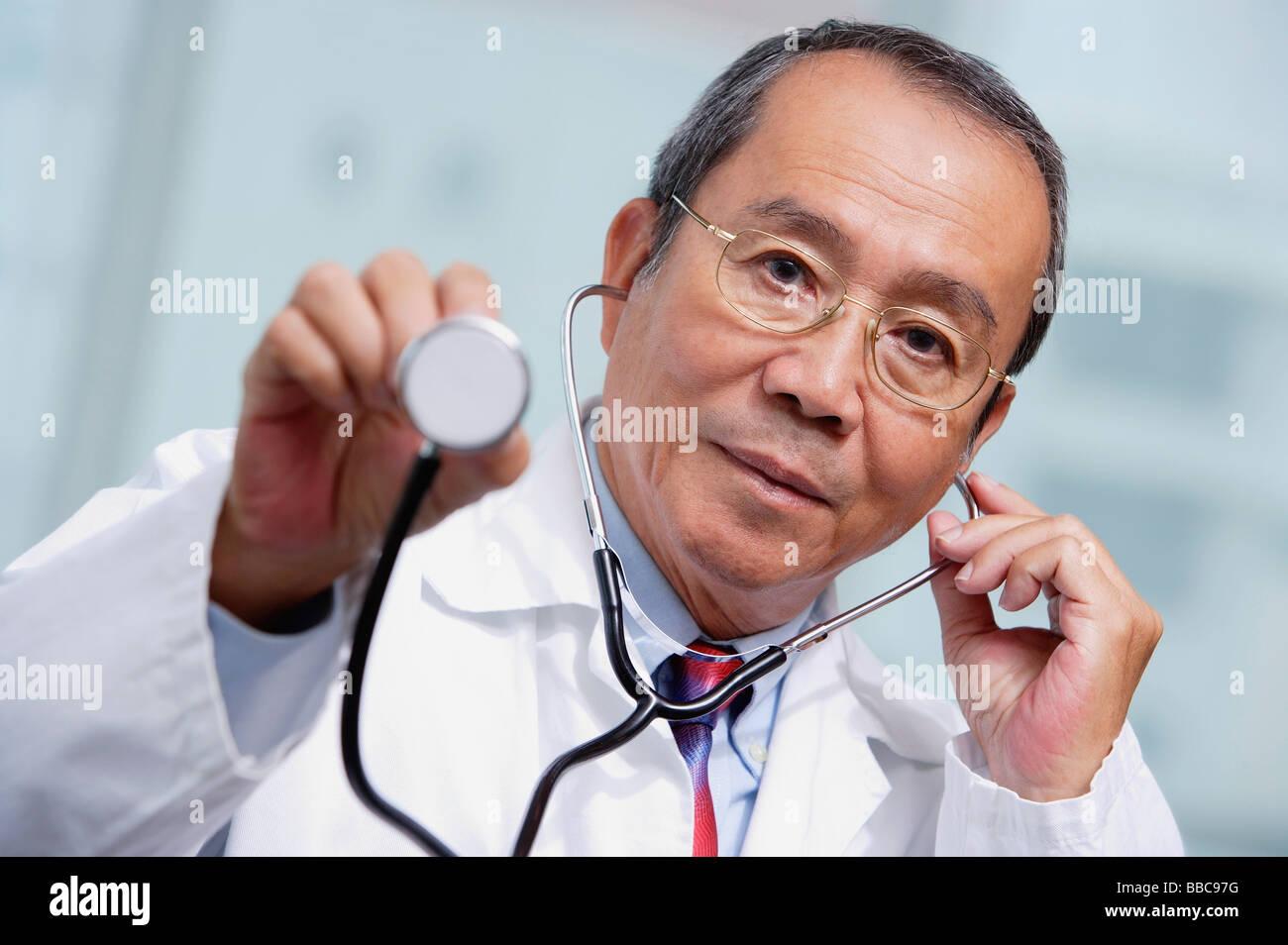 Doctor using stethoscope Stock Photo - Alamy