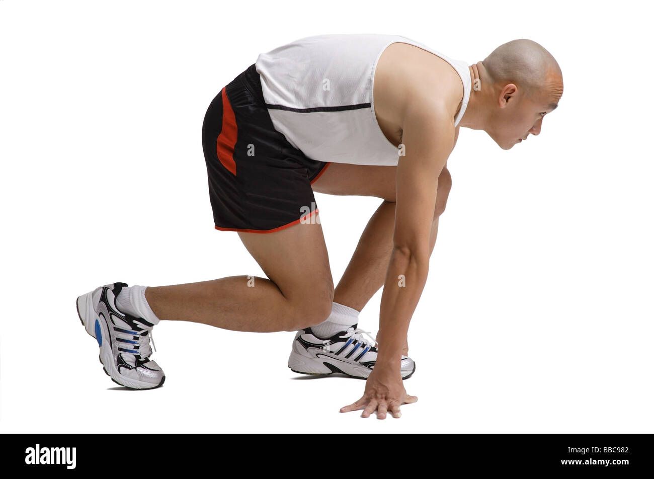 Runner in starting position, side view Stock Photo - Alamy
