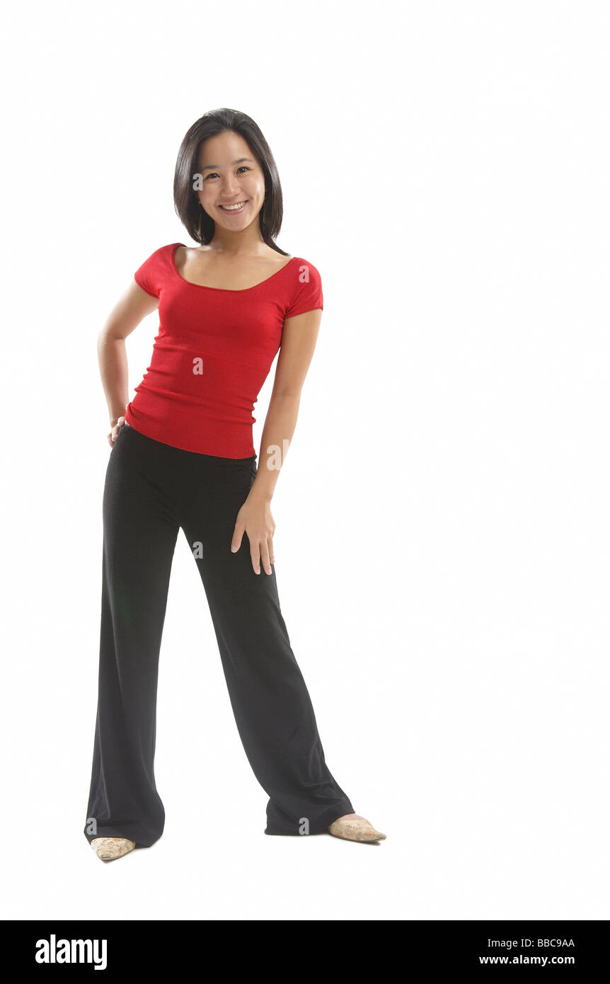 Young woman standing and smiling Stock Photo - Alamy