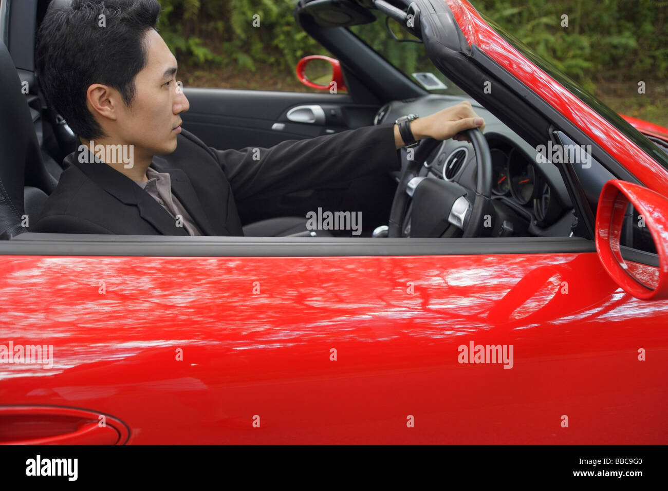 Man driving red convertible car Stock Photo - Alamy