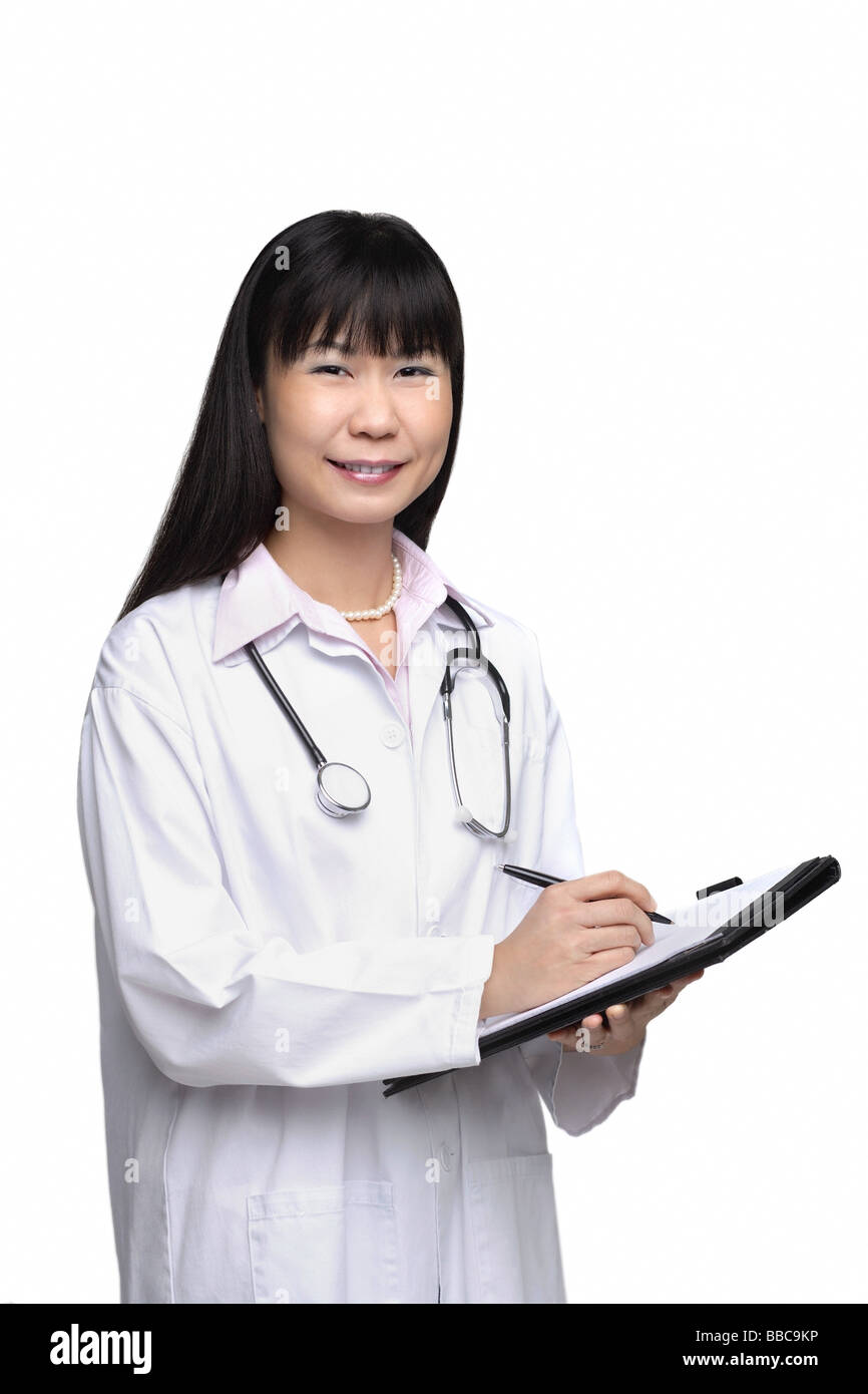 Doctor with medical chart, smiling at camera Stock Photo - Alamy