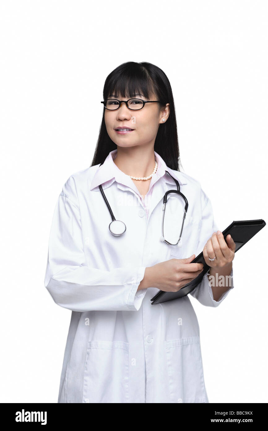 Female doctor holding medical chart, looking away Stock Photo - Alamy