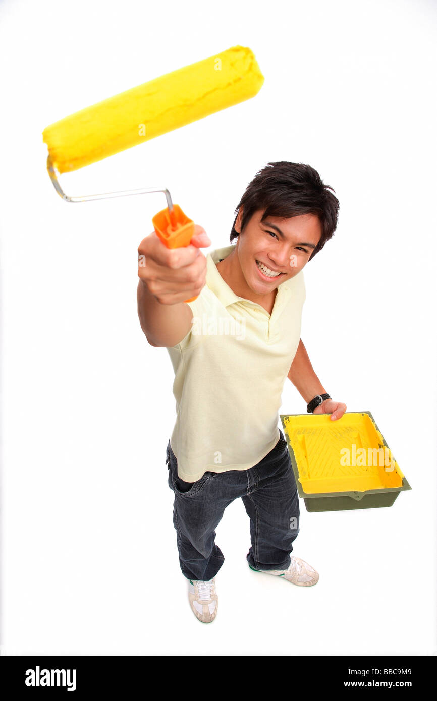Man holding paint roller and paint tray Stock Photo - Alamy